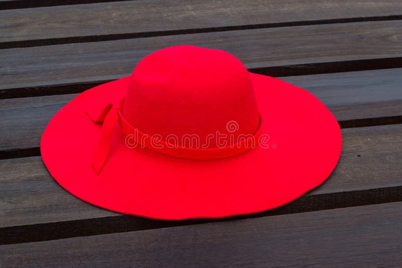 Red hat on wooden floor stock image. Image of texture - 73378237