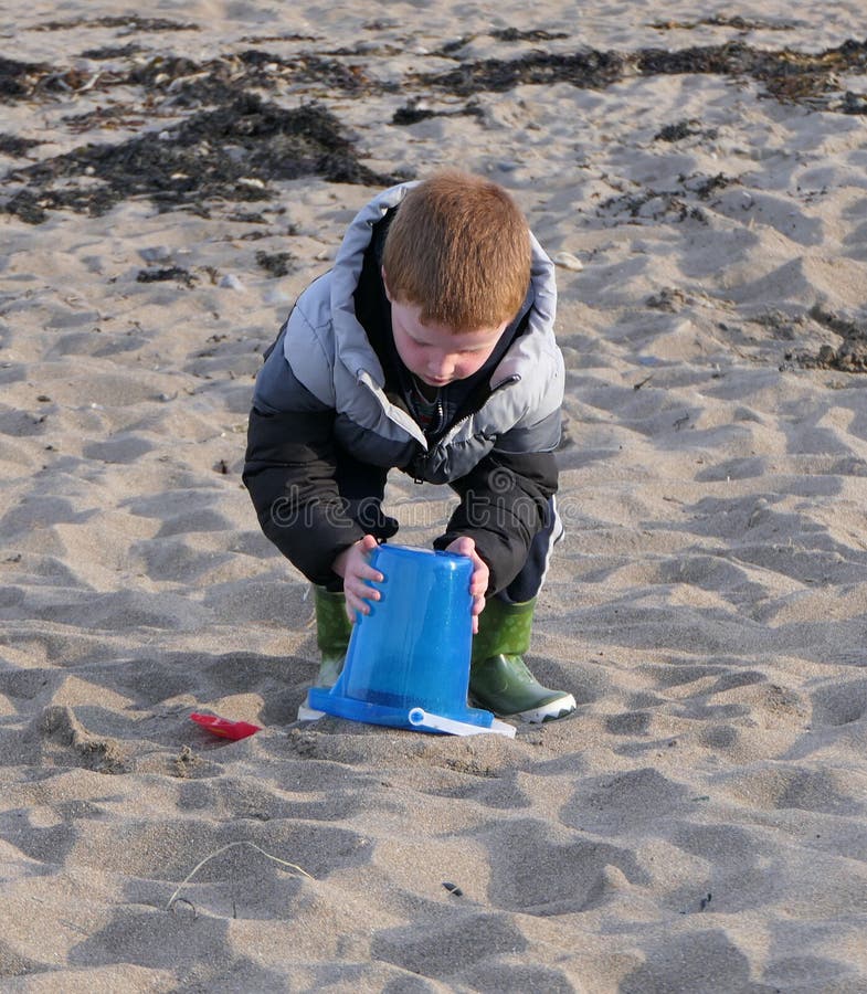 Red Headed Boy Playing with Bucket Spade and Digger on Sandy Beach ...