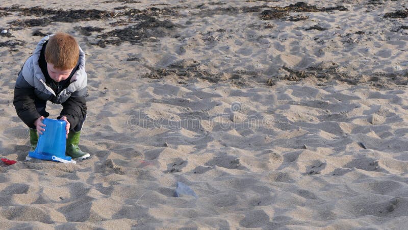 Red Headed Boy Playing with Bucket Spade and Digger on Sandy Beach ...