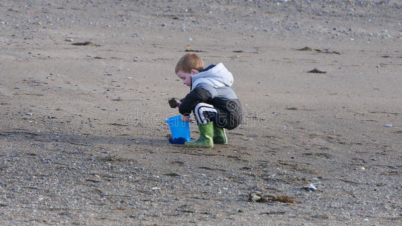 Red Headed Boy Playing with Bucket Spade and Digger on Sandy Beach ...