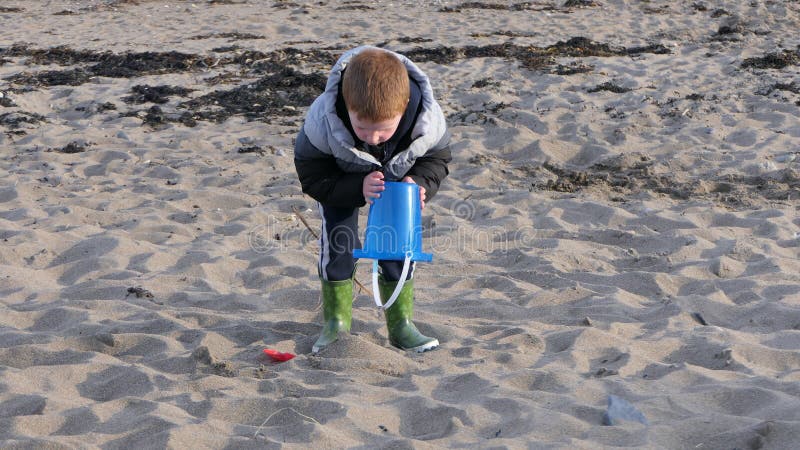 Red Headed Boy Playing with Bucket Spade and Digger on Sandy Beach ...