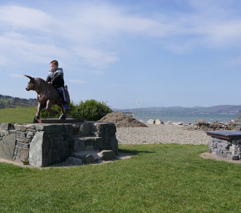 Red Headed Boy Riding a Statue Bull Ireland Stock Photo - Image of boat ...