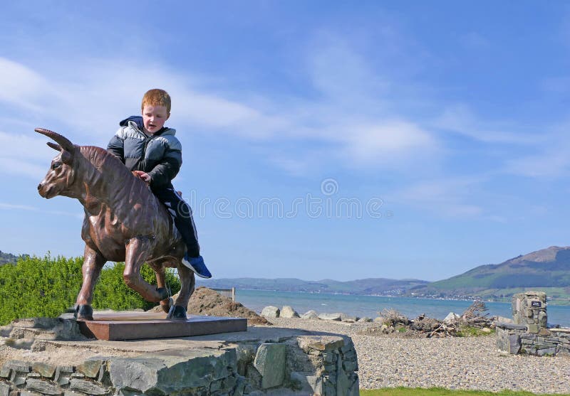 Red Headed Boy Riding a Statue Bull Ireland Stock Photo - Image of fish ...