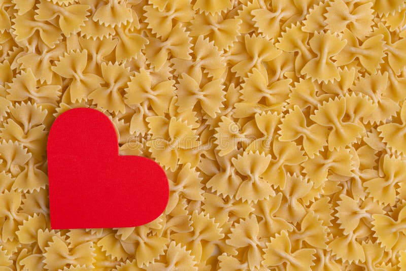 Red Heart on a Background of Farfalle Pasta, Copy-space Stock Photo ...