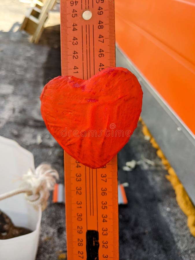 Red Heart Hanging on a Construction Tool Stock Photo - Image of ...
