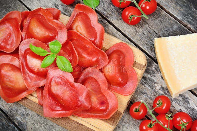 Red Heart Ravioli with Tomato, Mozzarella and Basil on a Vintage Table ...