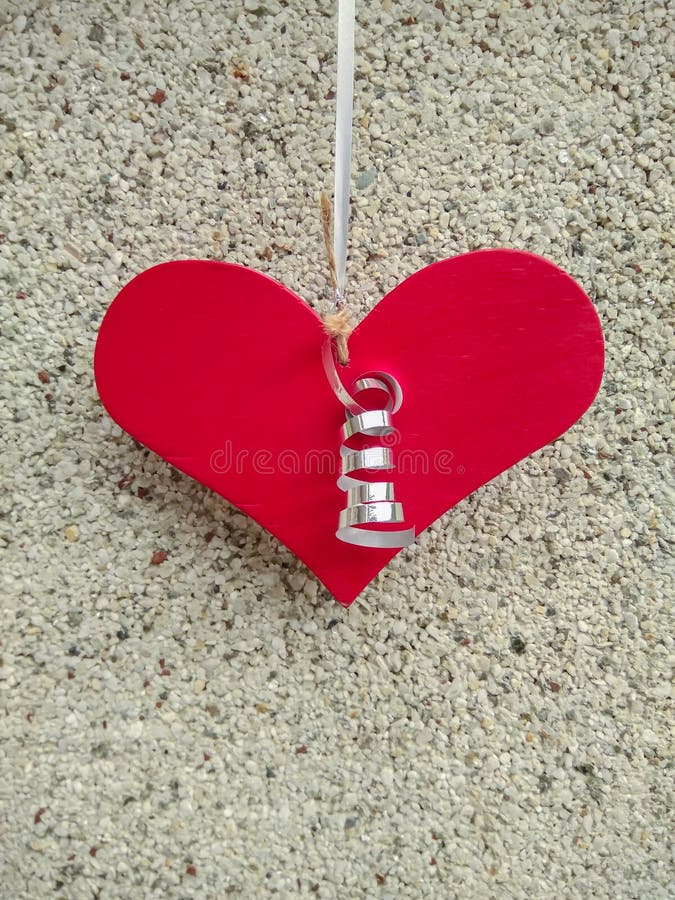 Red Heart of Wood Hanging on a Shiny Thread on the Background of the ...