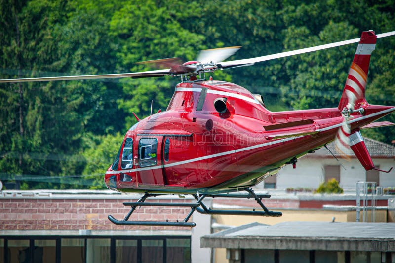 Red helicopter in flight stock photo. Image of colorful - 249306876