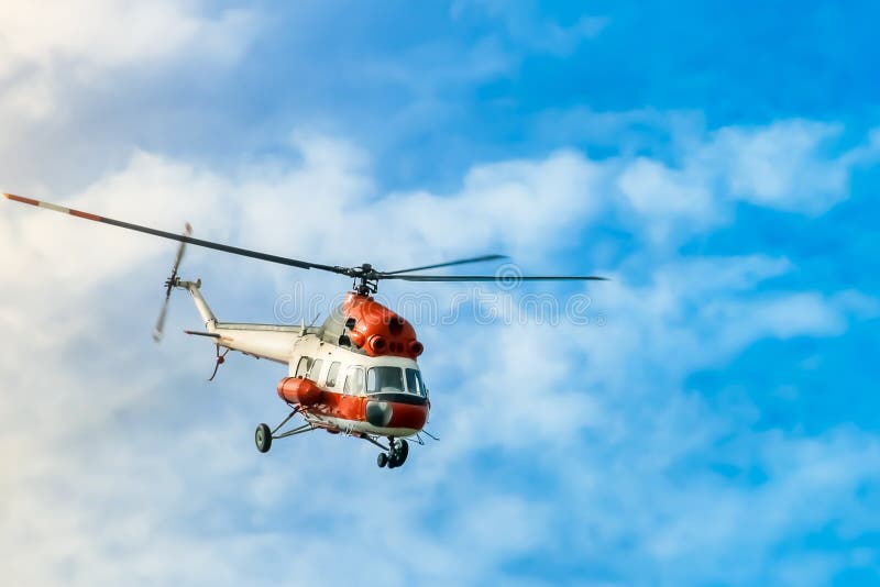 Red Helicopter Flying in Blue Cloudy Sky Stock Photo - Image of ...