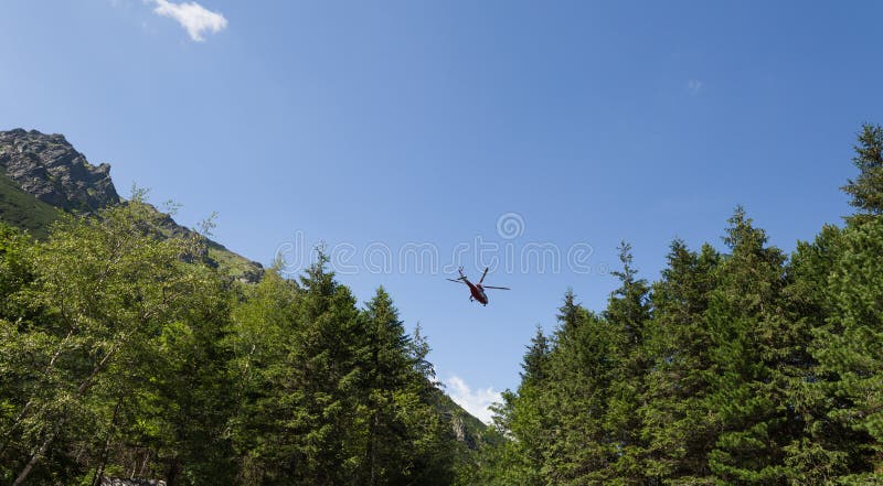 Red Helicopter is Flying between Mountains Peak, Summer Time Stock ...
