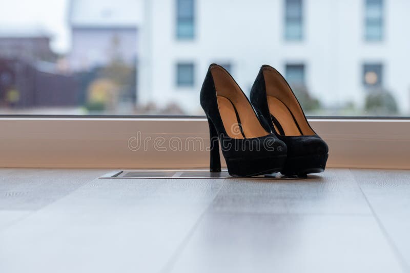 Black High Heel Pumps in Front of a Window and on a Light Floor Stock ...