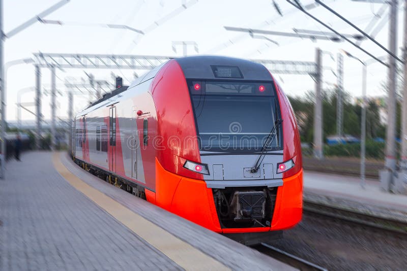 Red High Speed Passenger Train in Motion on the Railway Station Stock ...