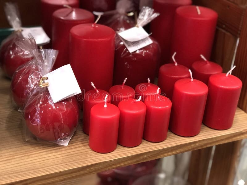 Red Home Candles of Different Shapes on Wooden Shelf. Spa. Cozy Home ...