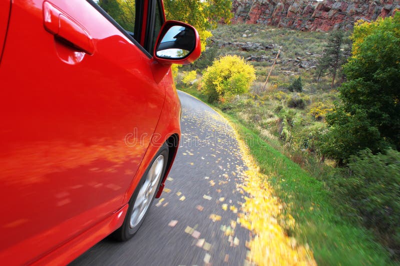 Red Honda Fit Driving in Fall Time Stock Photo - Image of yellow, side ...