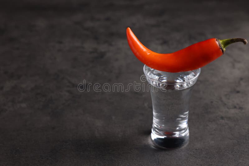 Red Hot Chili Pepper and Vodka in Shot Glass on Grey Table, Space for ...
