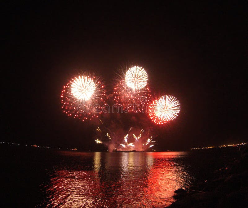 Red hot fireworks display stock photo. Image of water - 67192334