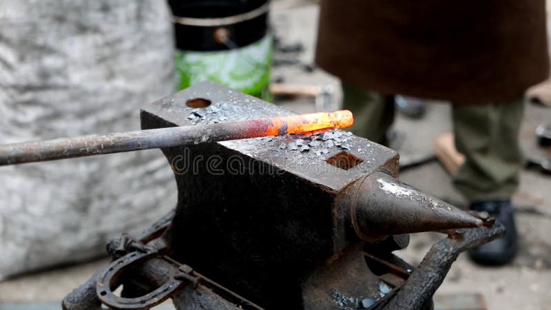 Red-hot Metal Detail and Blacksmith Hammer Tapping on it. Stock Footage ...