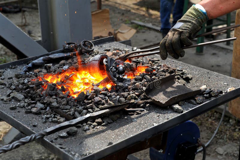 A Forging Furnace: Blacksmith Working Iron and Incandescent Charcoal ...