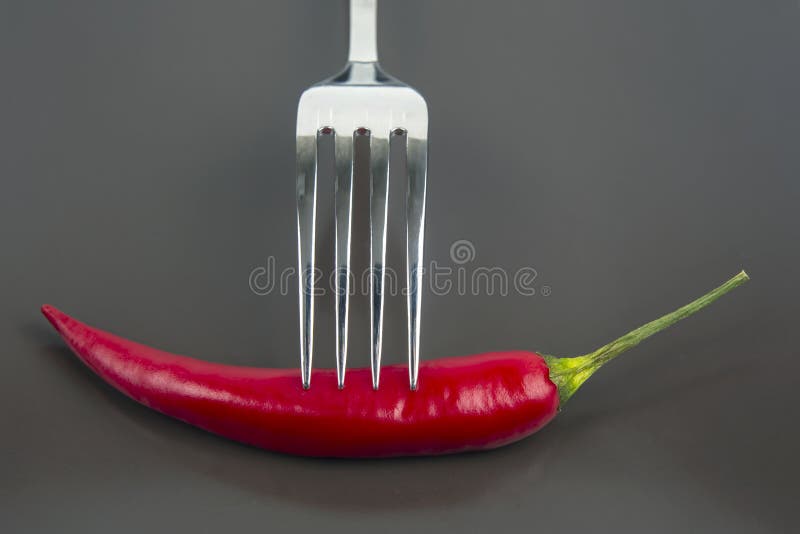 Red Hot Pepper on a Fork on a Ceramic Plate. Spices and Vegetative Food ...