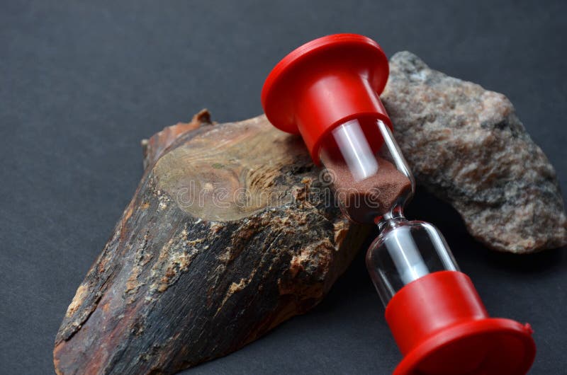 Red Hourglass Close-up on Wood on a Black Background. Stock Image ...