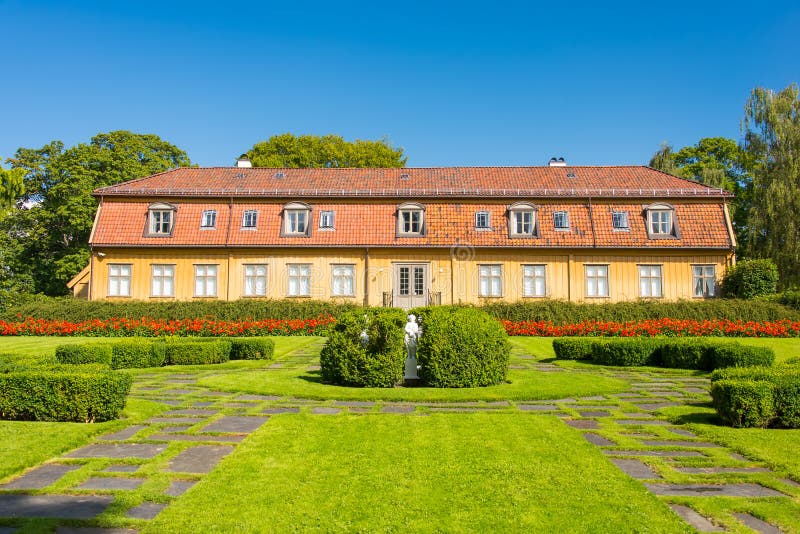Red house in garden stock photo. Image of landscaping - 26384680