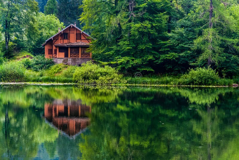Red house on the lake stock image. Image of love, building - 47693095