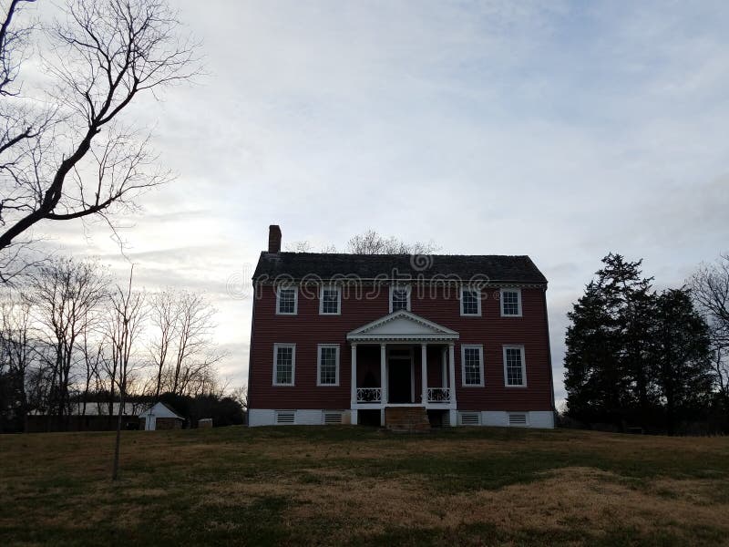Red House with Pillars and Trees and Grass Stock Image - Image of trees ...