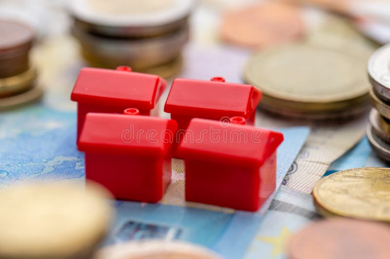 Red Houses by Stacks of Coins Representing House Financing.. Stock ...