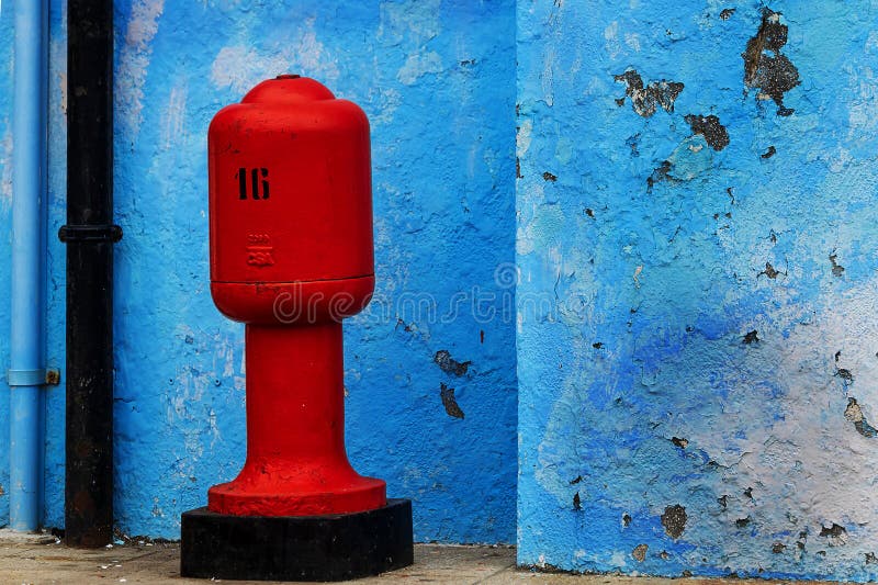 Red Hydrant by the Blue Wall Stock Photo - Image of urban, outside ...