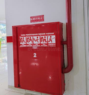 A Red Hydrant Box is Installed on a White Wall with a Sticker on How To ...