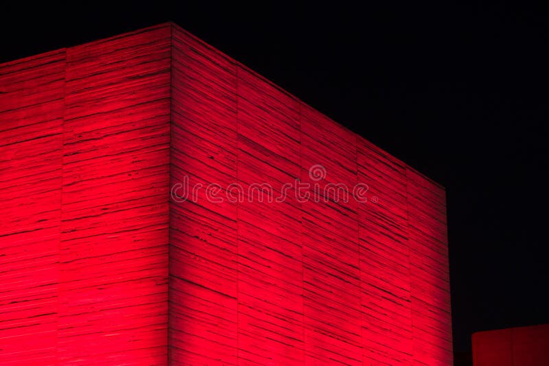 Red Illuminated Concrete Wall of Brutalist Building at Night Stock ...