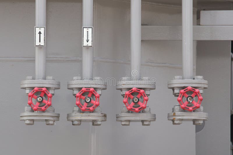 Red Industrial Valves in a Row on Gray Pipelines System Stock Photo ...