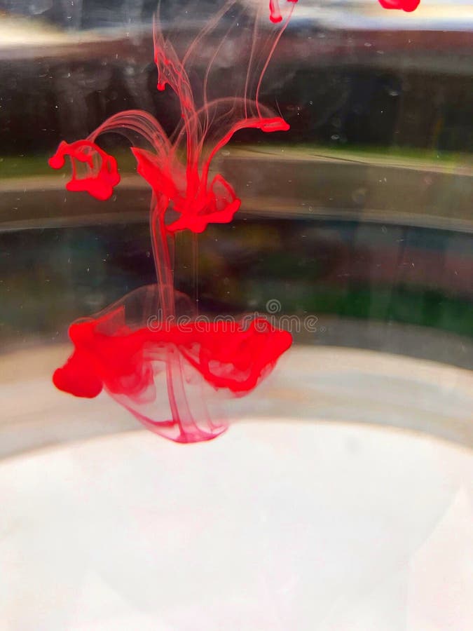 Red ink drops in water stock photo. Image of painting - 141799228