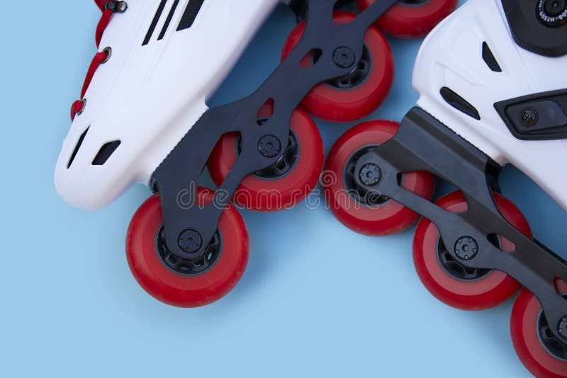 Red Inline Skate Wheels on Blue Background Stock Image - Image of ...