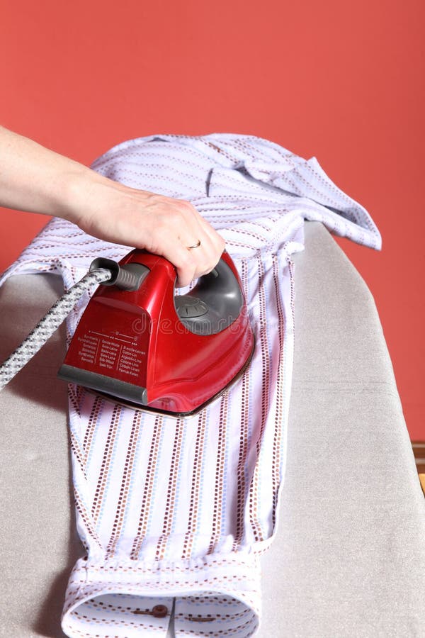 Red Iron in hand and shirt stock image. Image of effort - 24831243