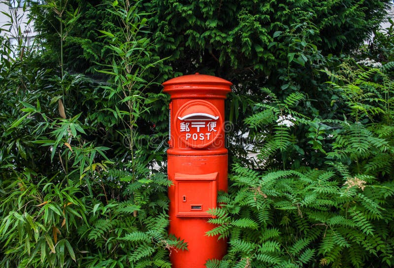 Red Japan Post Mailbox Surrounded by Green Shrubbery Stock Photo ...