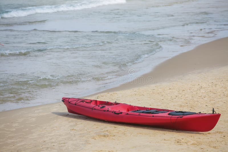 Red Kayak on a Sandy Beach at the Water S Edge Stock Photo - Image of ...