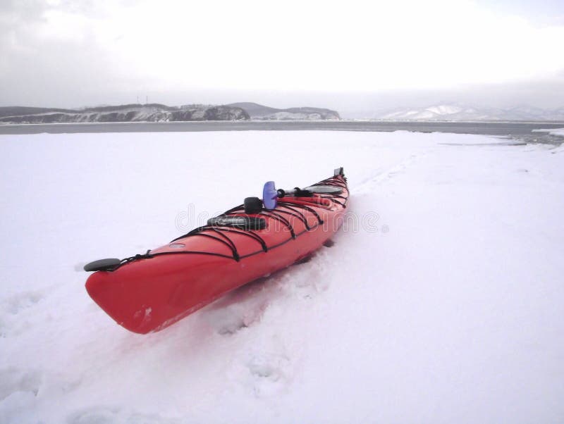 Red Kayak on the Ice Covered with Snow Stock Photo - Image of kayak ...