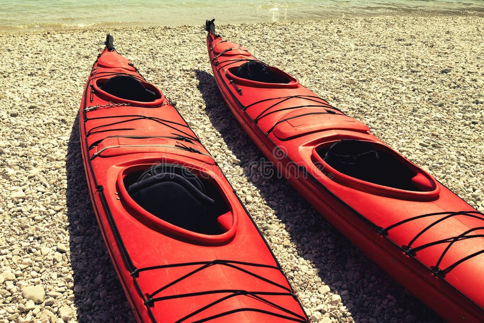 Red kayaks on the beach stock image. Image of bright - 74560703