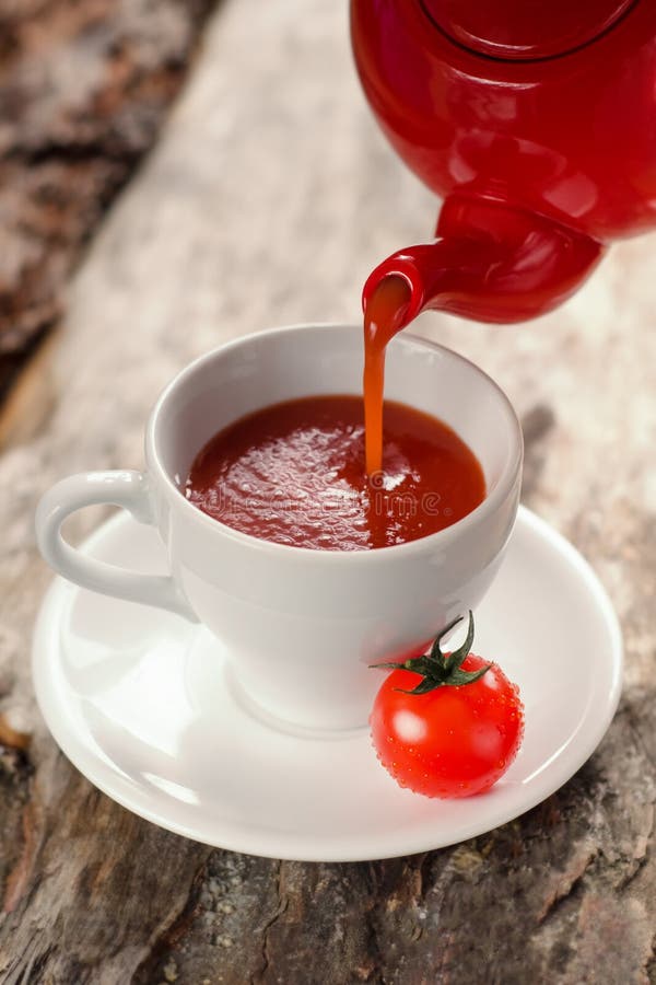 Red Kettle is Pouring Tomato Juice in a White Cup Stock Image - Image ...