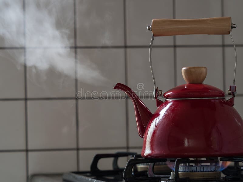 Red kettle steaming hot. stock photo. Image of reflective - 155996432
