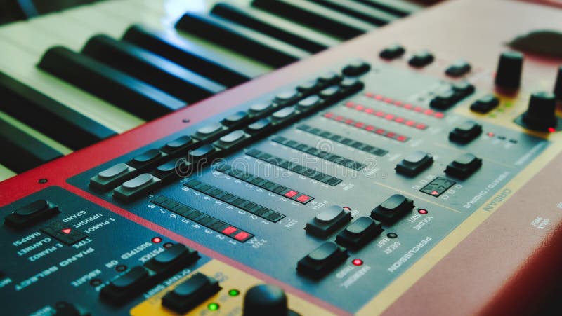 Close-up of a Red Synthesizer with Knobs and LEDs for Hammond Organ ...