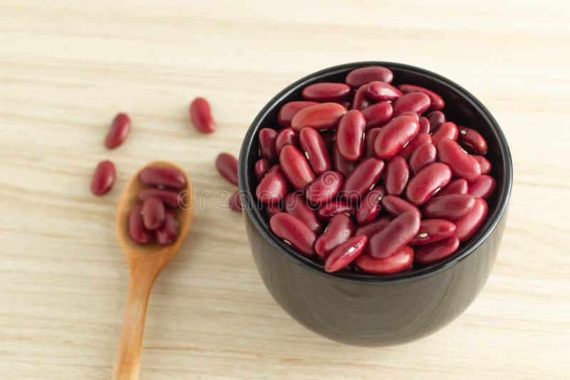 Red Kidney Beans in a Black Bowl and Spoon on Wooden Background, Front ...