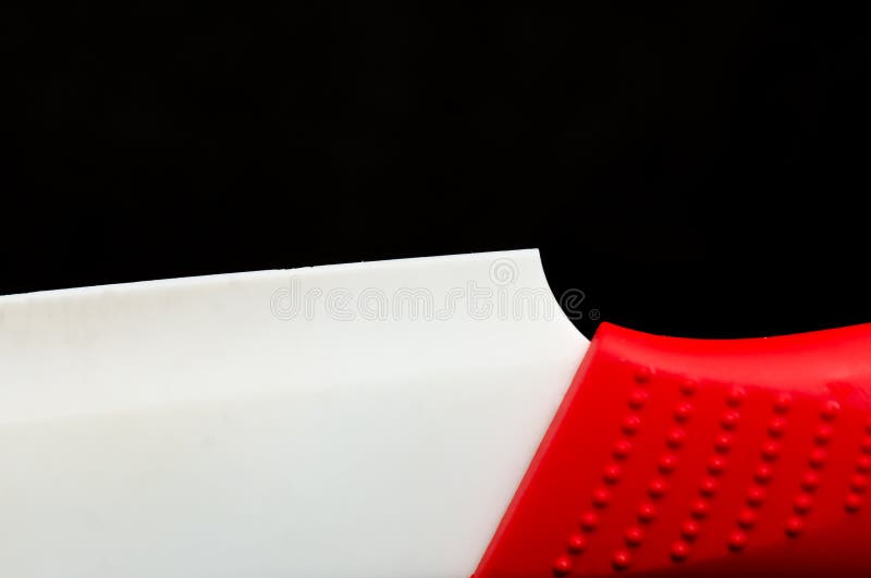 Red Knife with White Sharp Ceramic Blade Isolated on Black Background ...