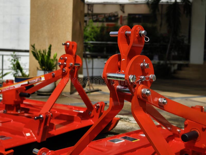Red Large Excavators are Stationed in a Green Field in Front of a ...
