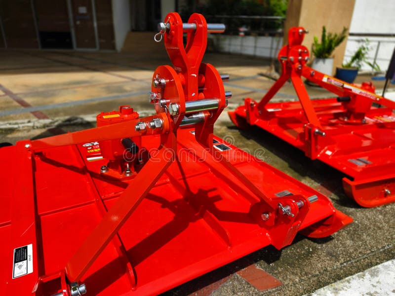 Red Large Excavators are Stationed in a Green Field in Front of a ...