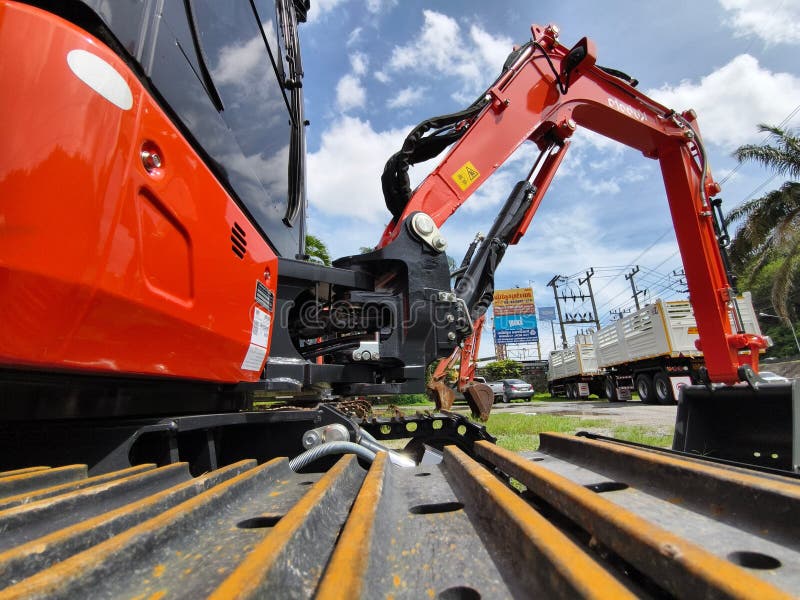 Red Large Excavators are Stationed in a Green Field in Front of a ...