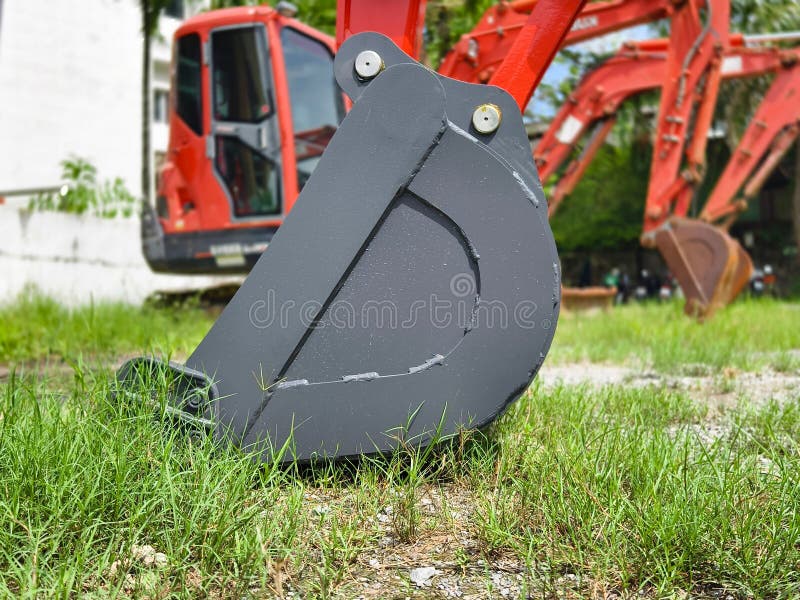 Red Large Excavators are Stationed in a Green Field in Front of a ...