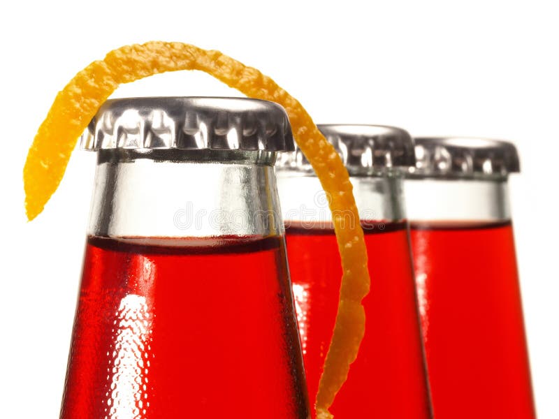 Red Lemonade with Orange Twist in Bottles on White Background Stock ...