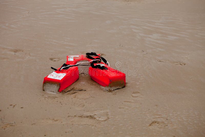 Red Life Jacket Washed Up on Sand Beach Stock Photo - Image of lost ...